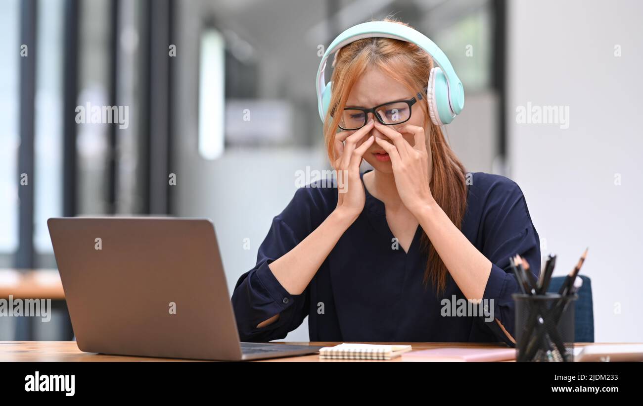 Tired asian female office worker suffering from blurry vision symptoms ...
