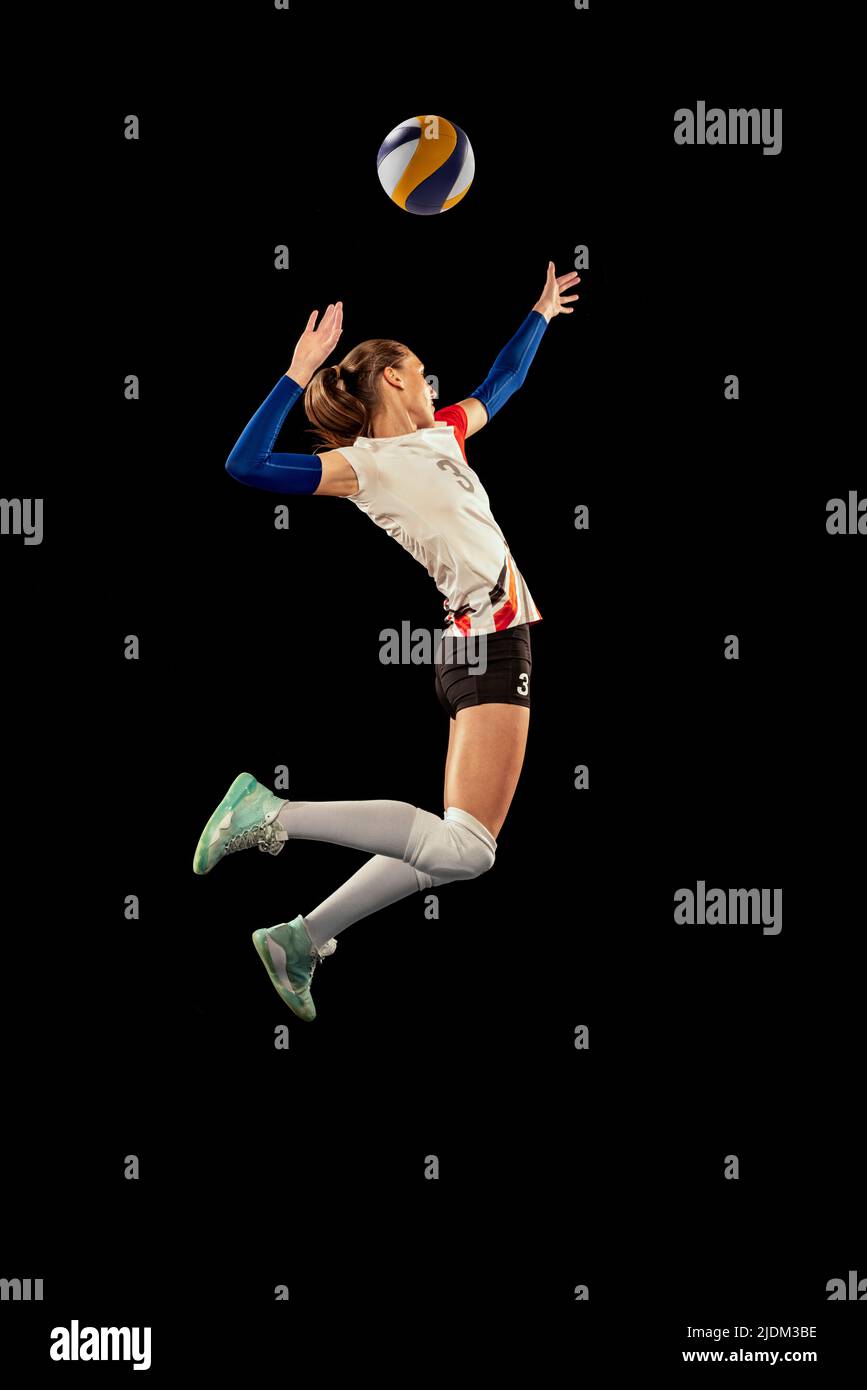 Dynamic portrait of professional volleyball player in sports uniform ...