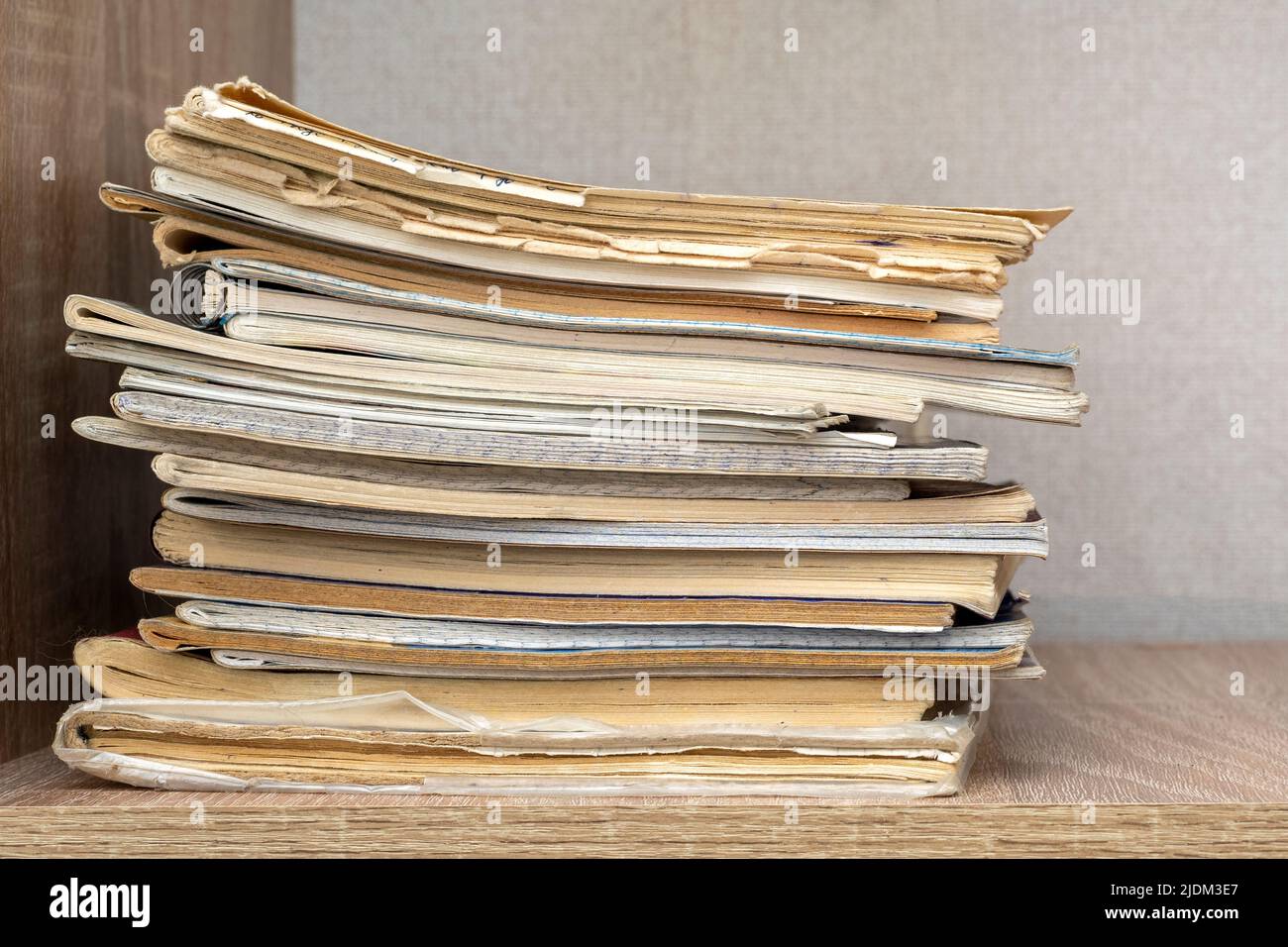 Stacked in a row old vintage study notepads on wooden shelf Stock Photo ...
