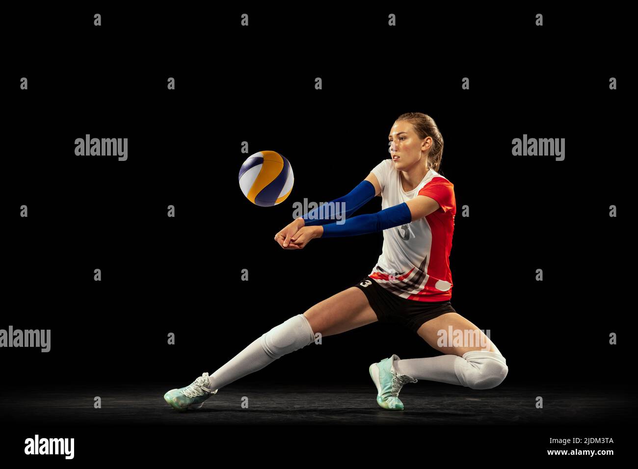 Dynamic portrait of professional volleyball player in sports uniform ...