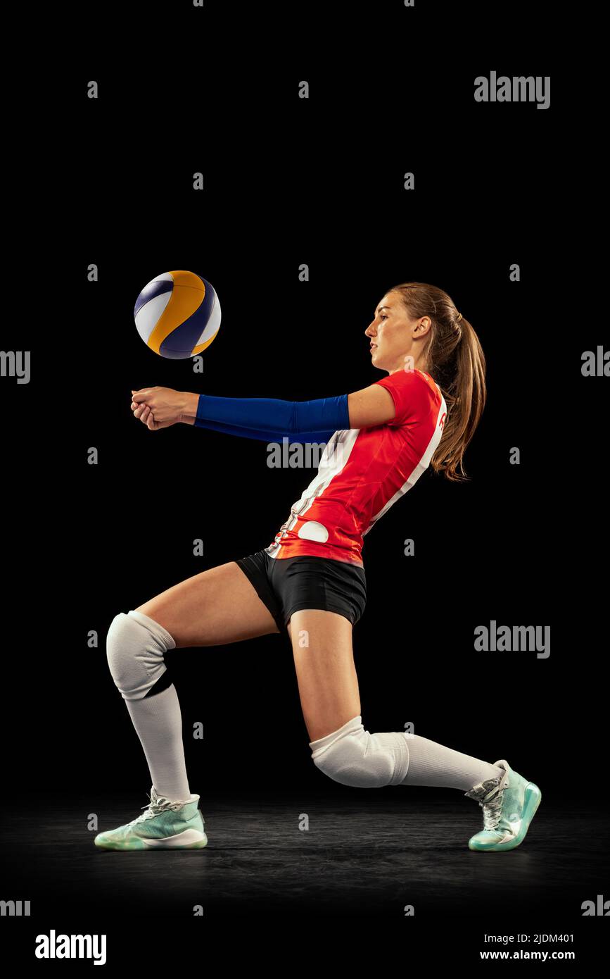 Dynamic portrait of professional volleyball player in sports uniform ...