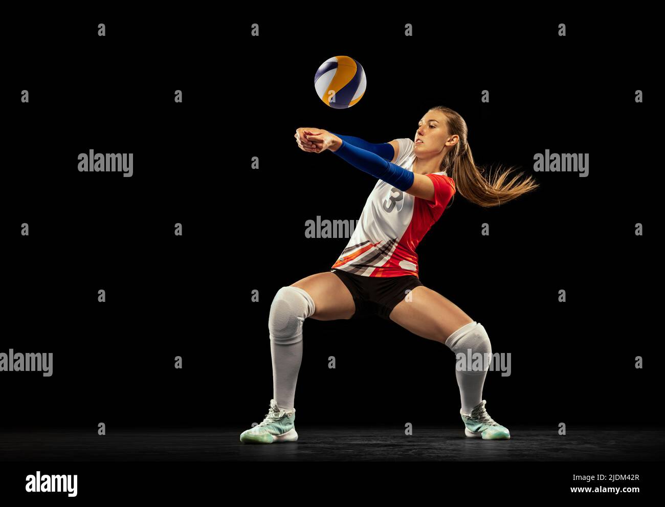 Dynamic portrait of professional volleyball player in sports uniform ...