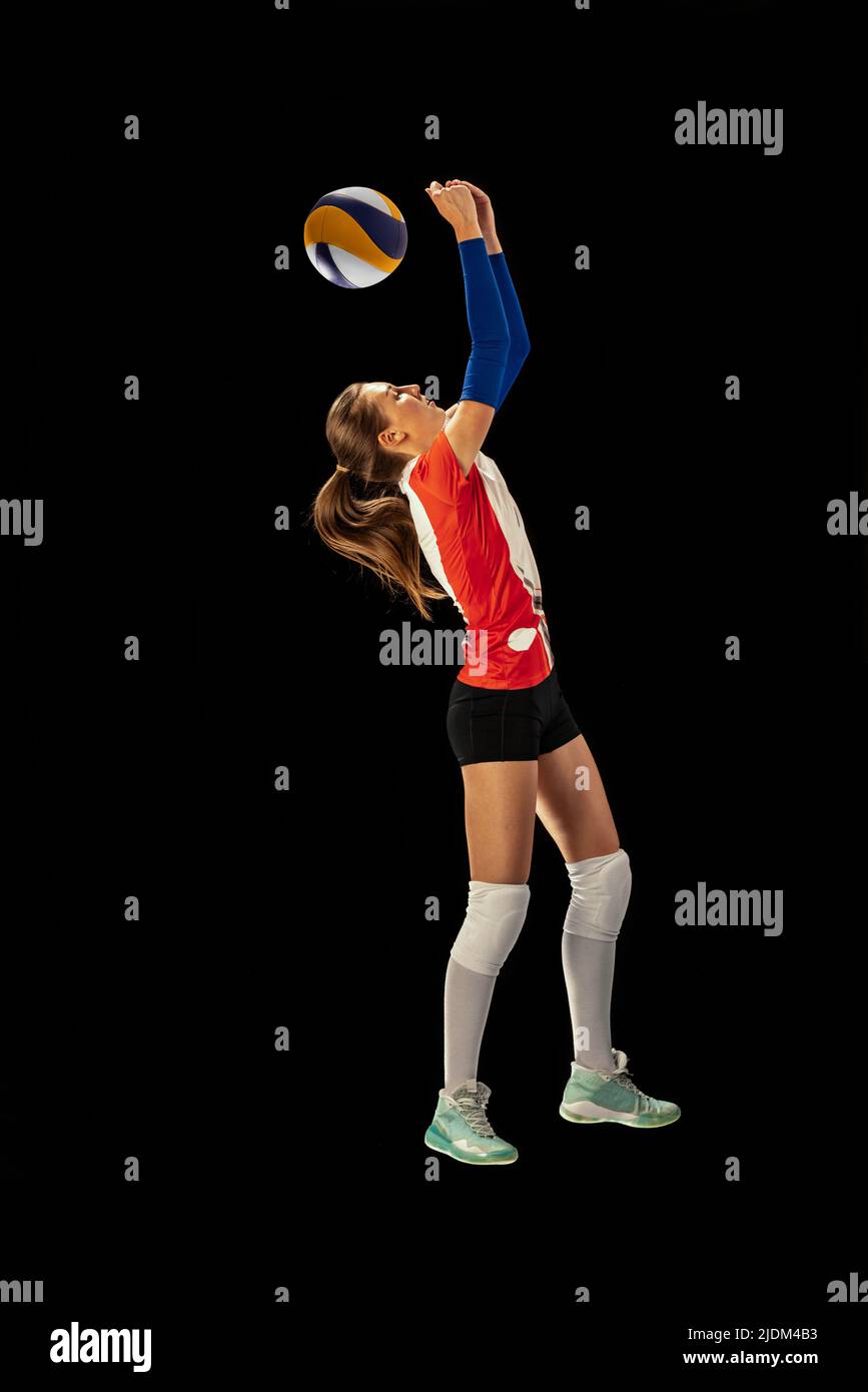 Dynamic portrait of professional volleyball player in sports uniform ...