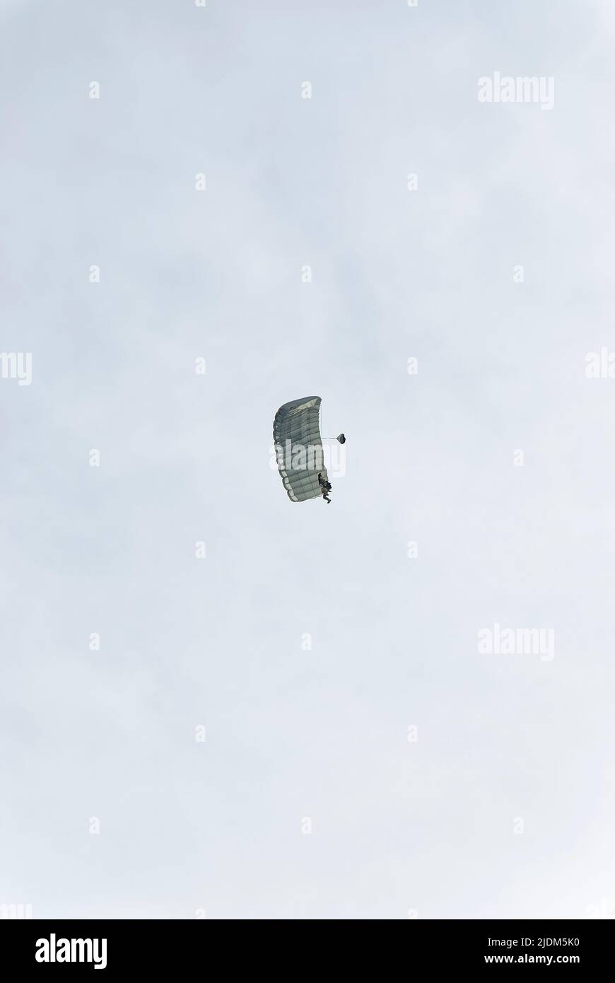 A paratrooper is flying. Photo taken during the parachute jumping show ...