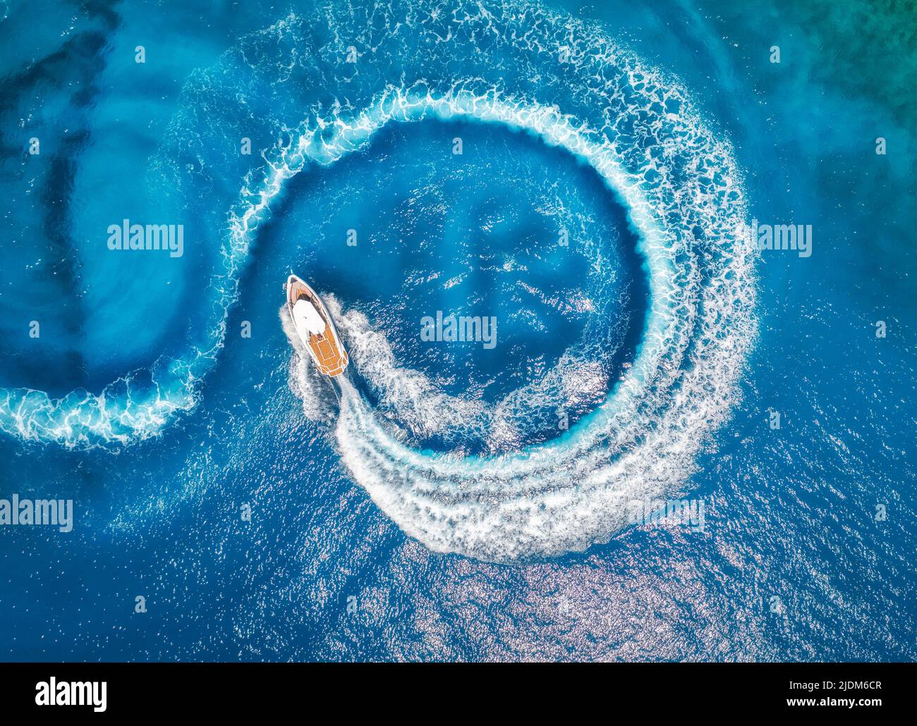 Aerial view of the speed boat in clear blue water at sunset Stock Photo ...
