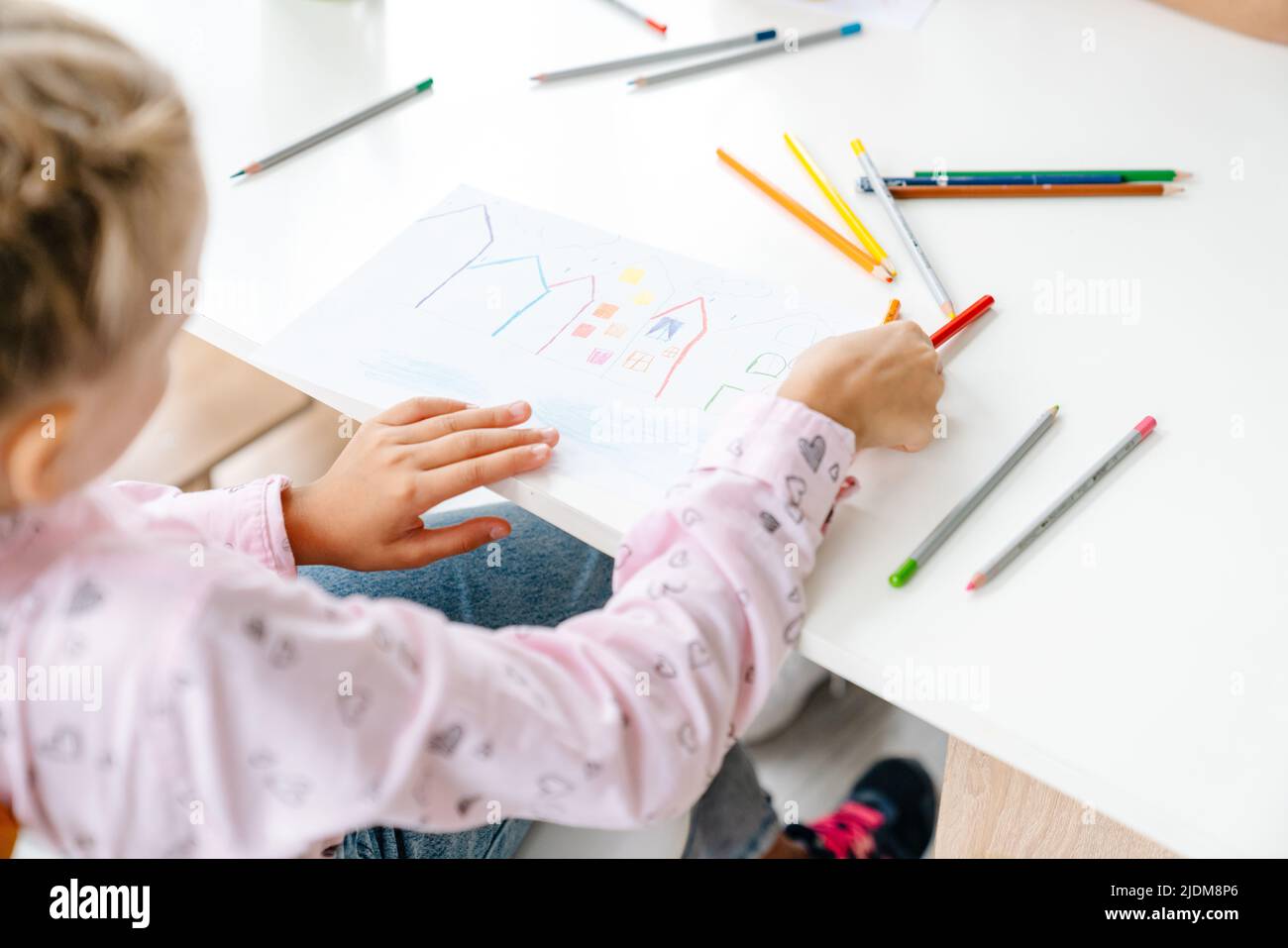 White blonde girl drawing during class in art school indoors Stock ...