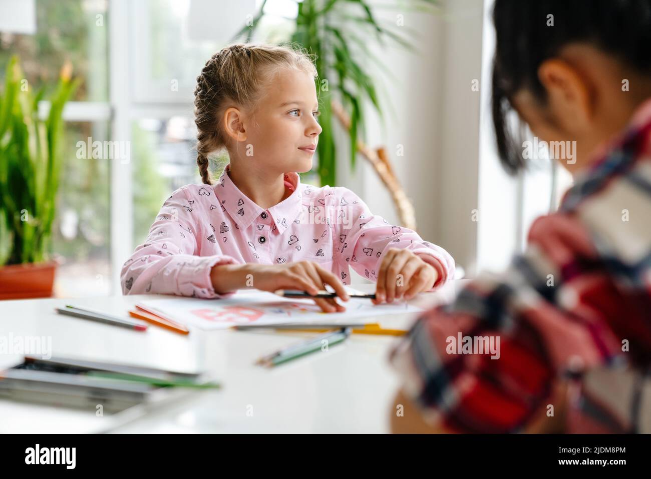 Multiracial two girls drawing during class in art school indoors Stock ...