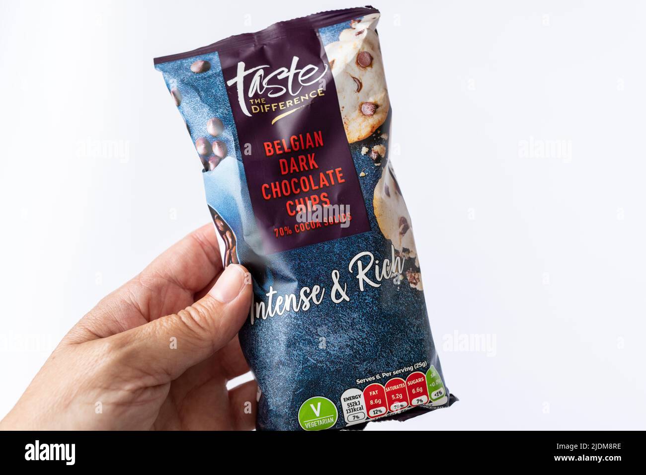 Female hand holding a pack of Sainsburys Taste The Difference dark ...
