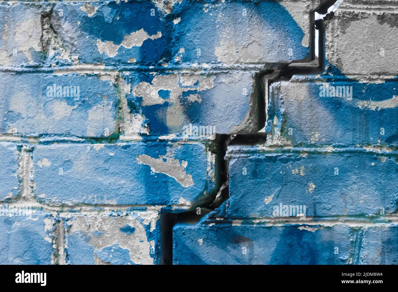 Crack on old brick broken wall with blue paint texture damaged ...