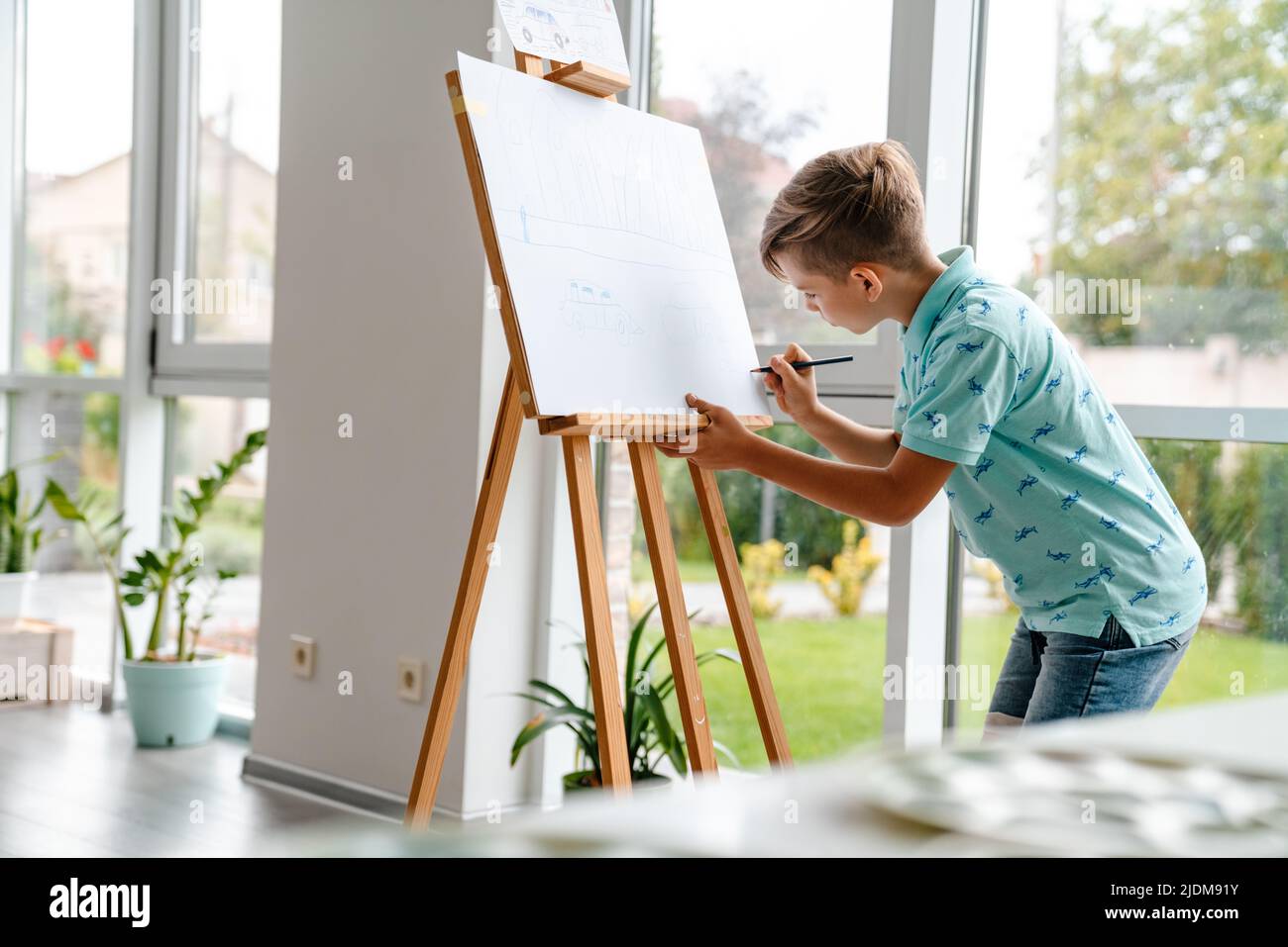 White blonde boy drawing during class in art school indoors Stock Photo ...