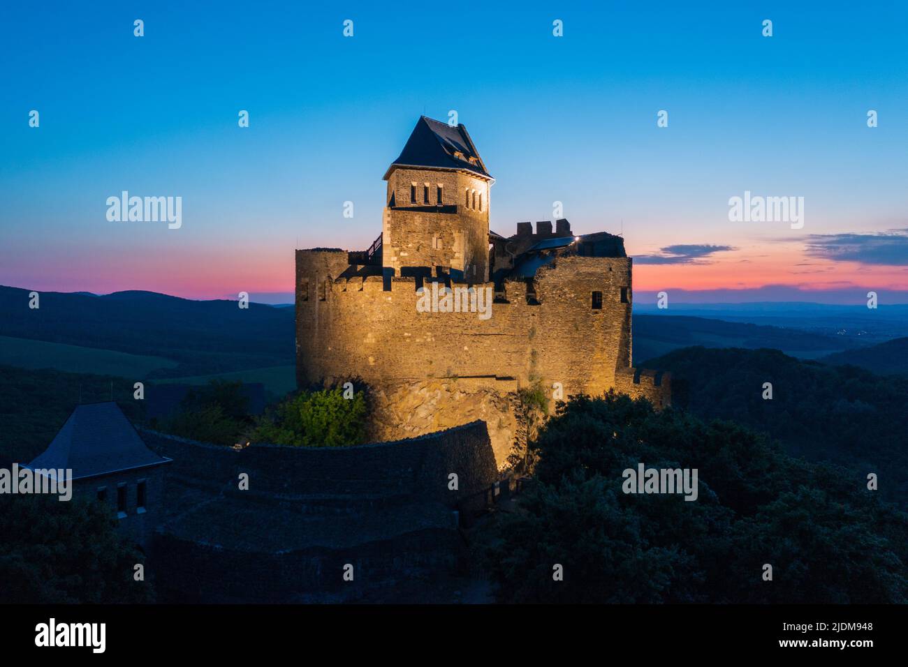 Aerial view about castle of Hollókő at dusk. Located in the mountains ...