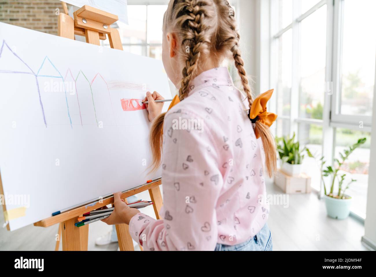 White blonde girl drawing during class in art school indoors Stock ...