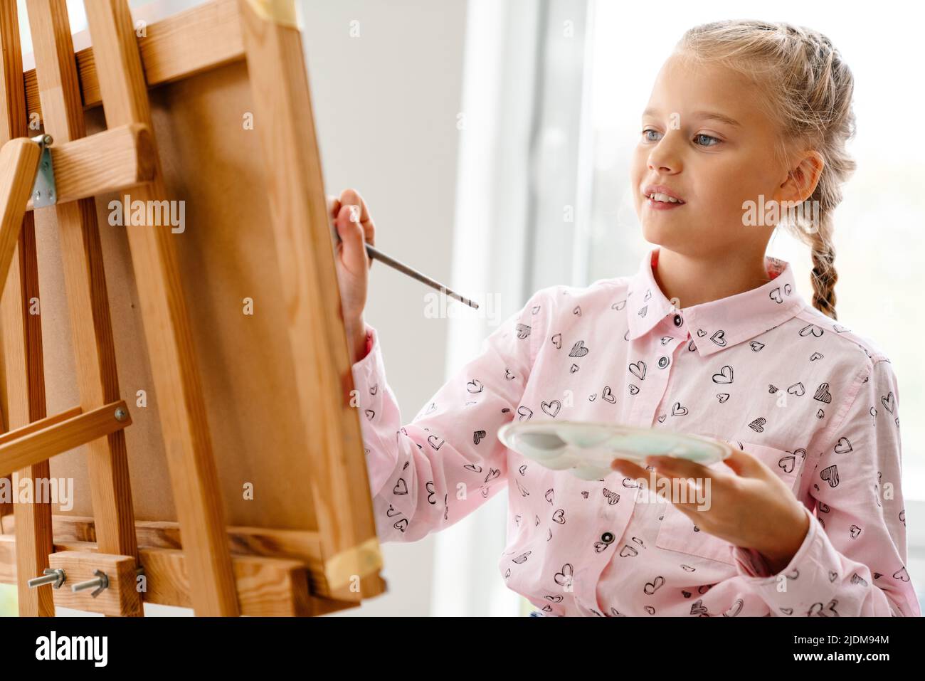 White blonde girl drawing during class in art school indoors Stock ...