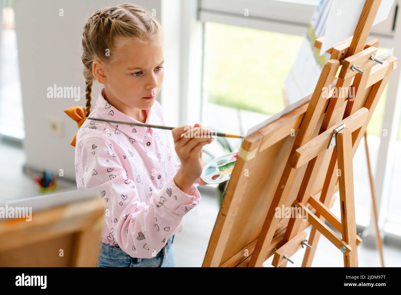 White blonde girl drawing during class in art school indoors Stock ...