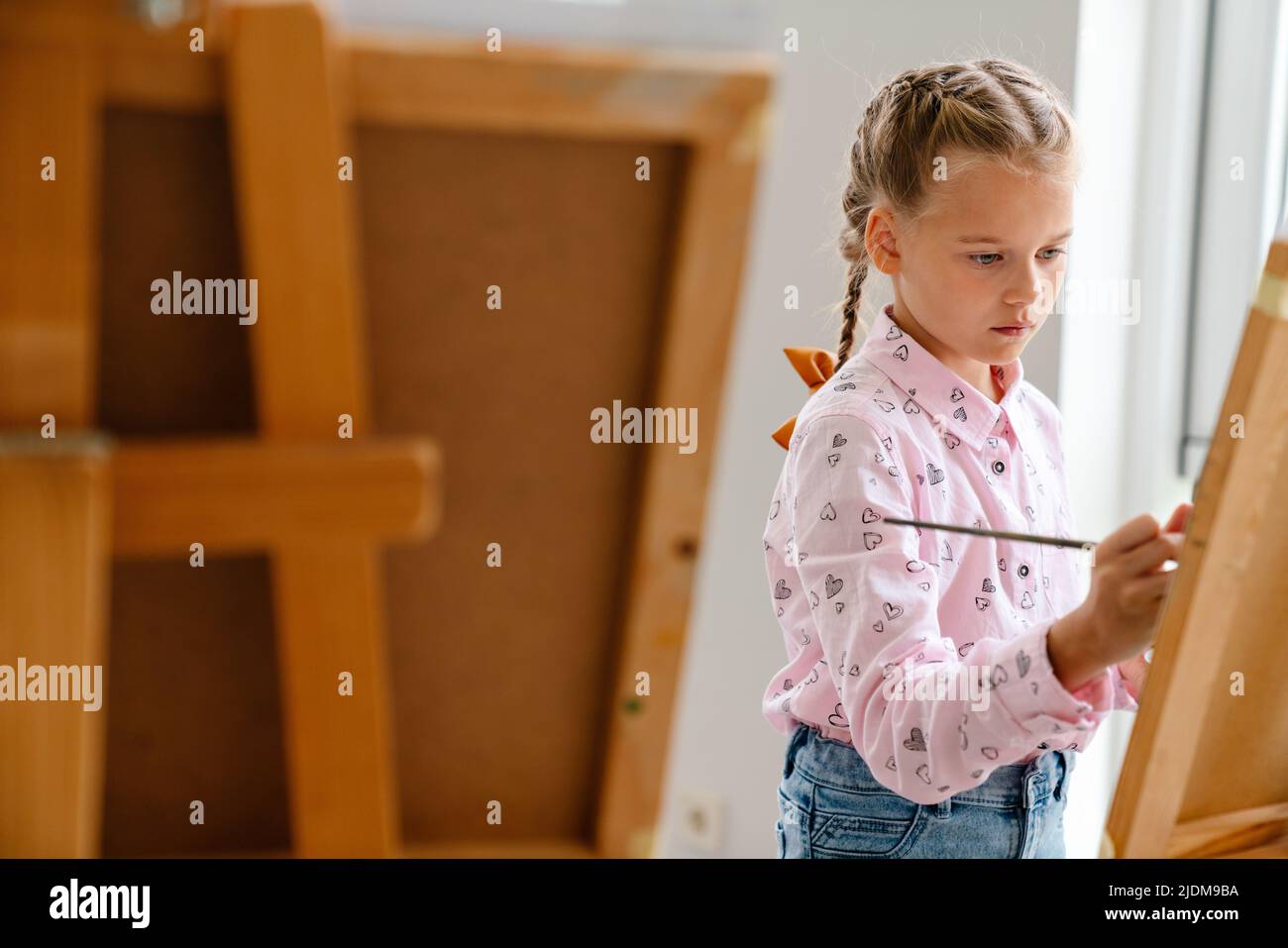 White blonde girl drawing during class in art school indoors Stock ...