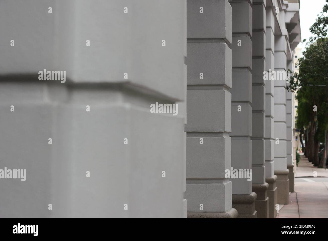 A row of elegant beautiful columns marching down the city sidewalk in ...