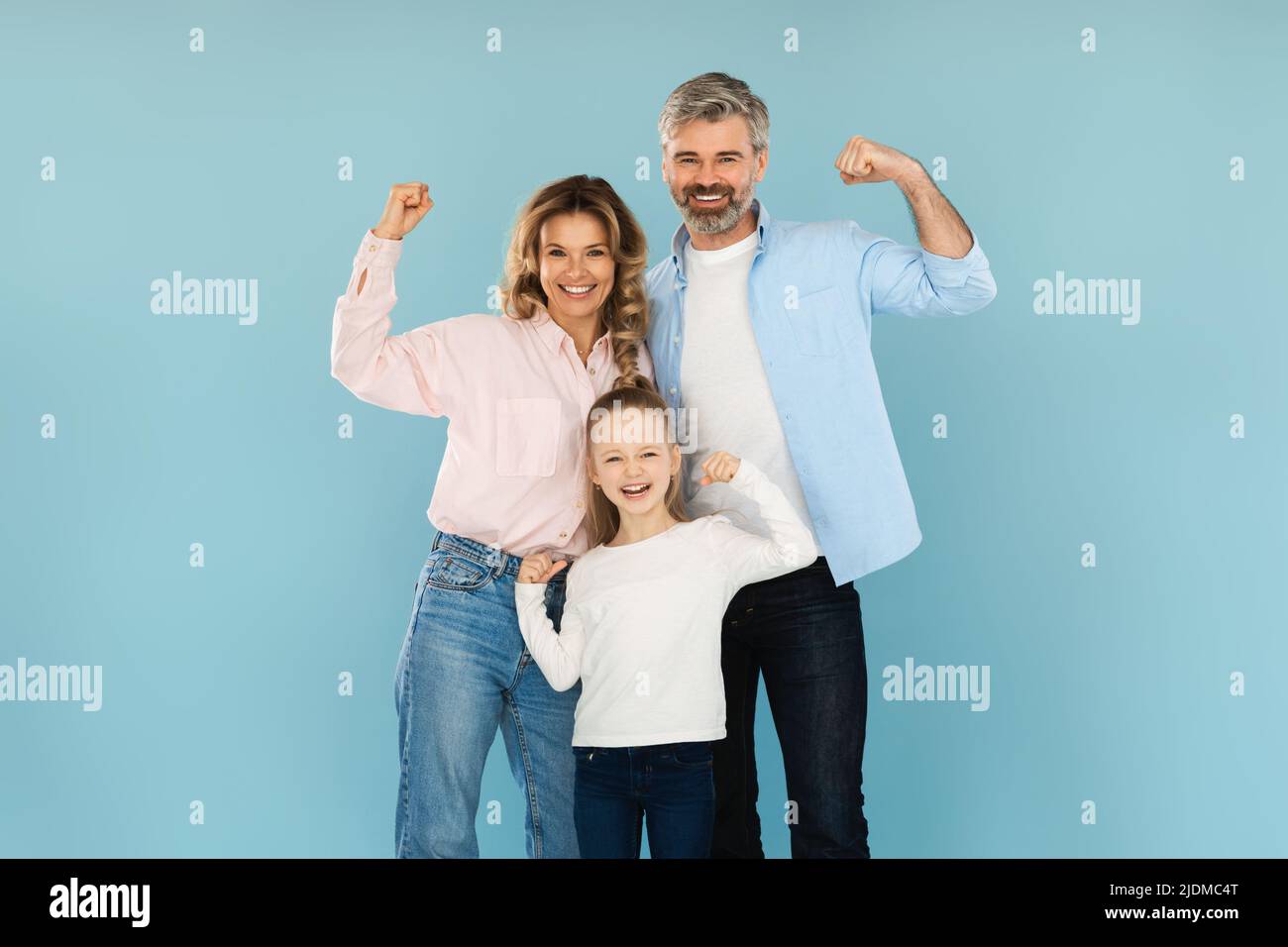 Cheerful Family Showing Biceps Muscles On Blue Background Stock Photo ...