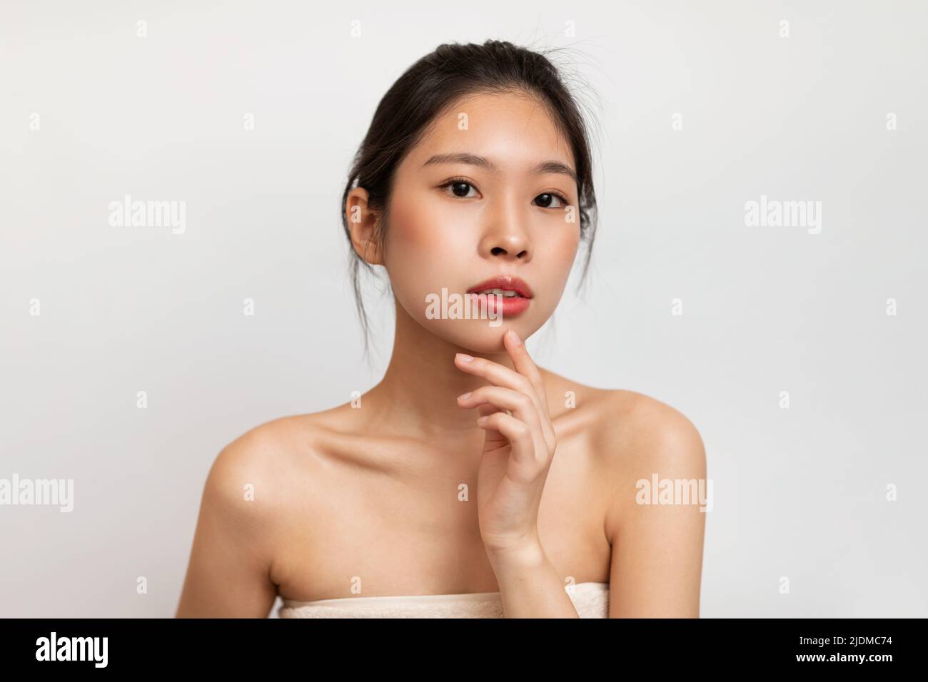 Young pretty korean lady enjoying perfect soft skin after spa ...