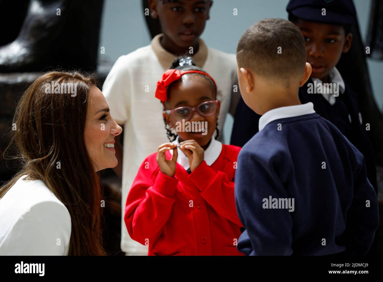 The Duchess of Cambridge speaks with children at the unveiling of the ...