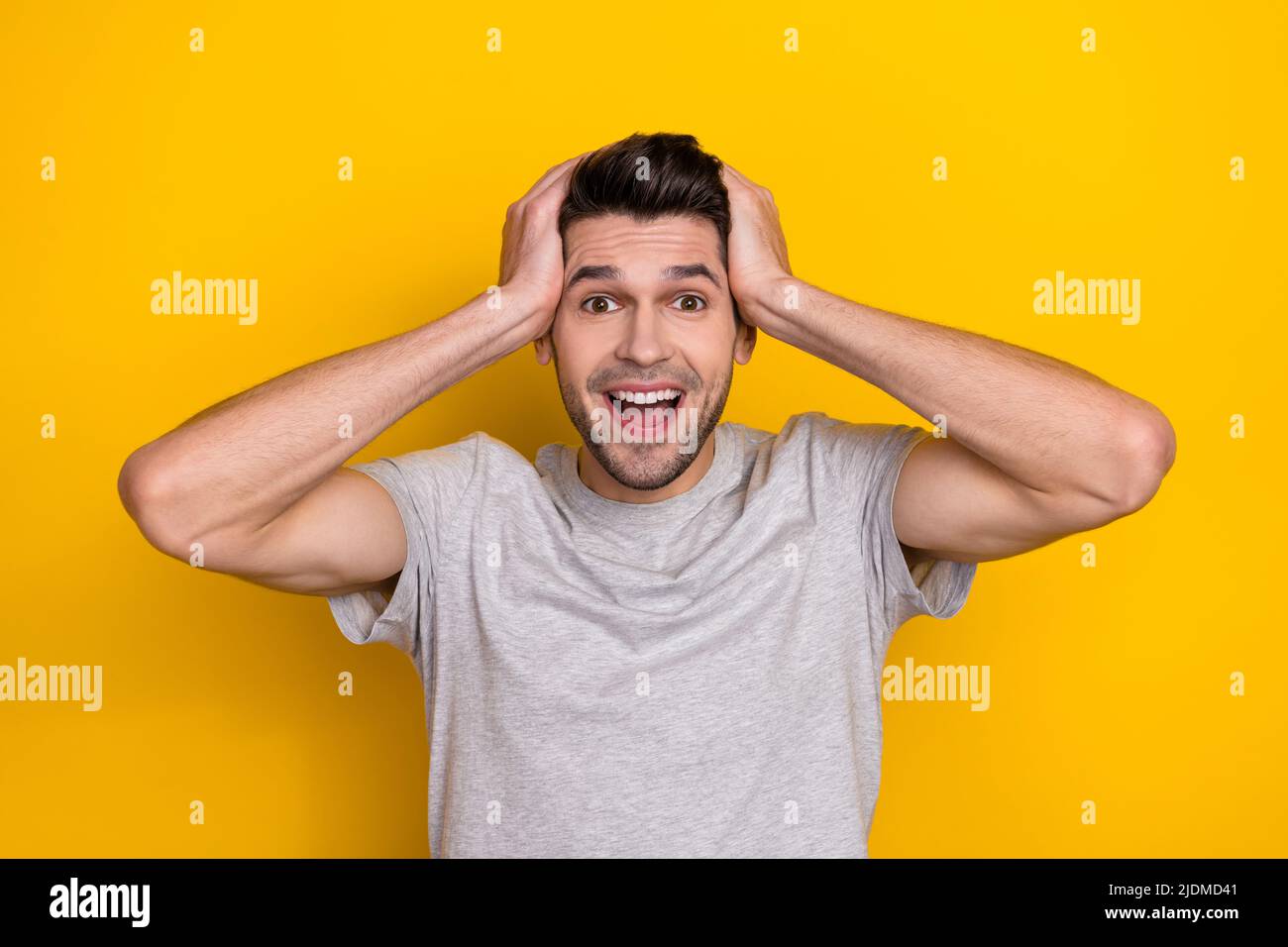 Photo of impressed brunet young guy palms head wear trend cloth ...