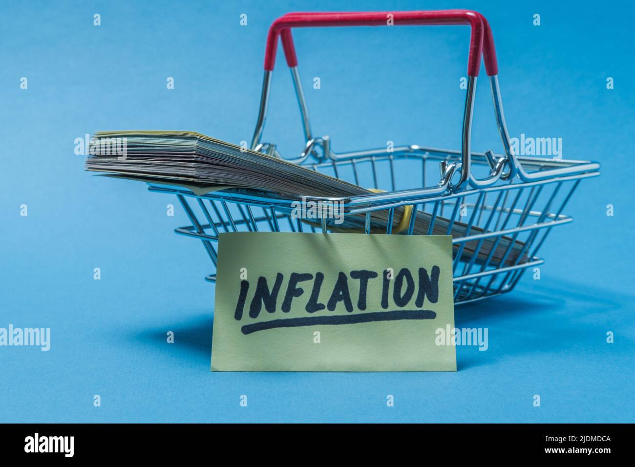 Dollars are in a grocery basket, with a poster on which the inscription ...