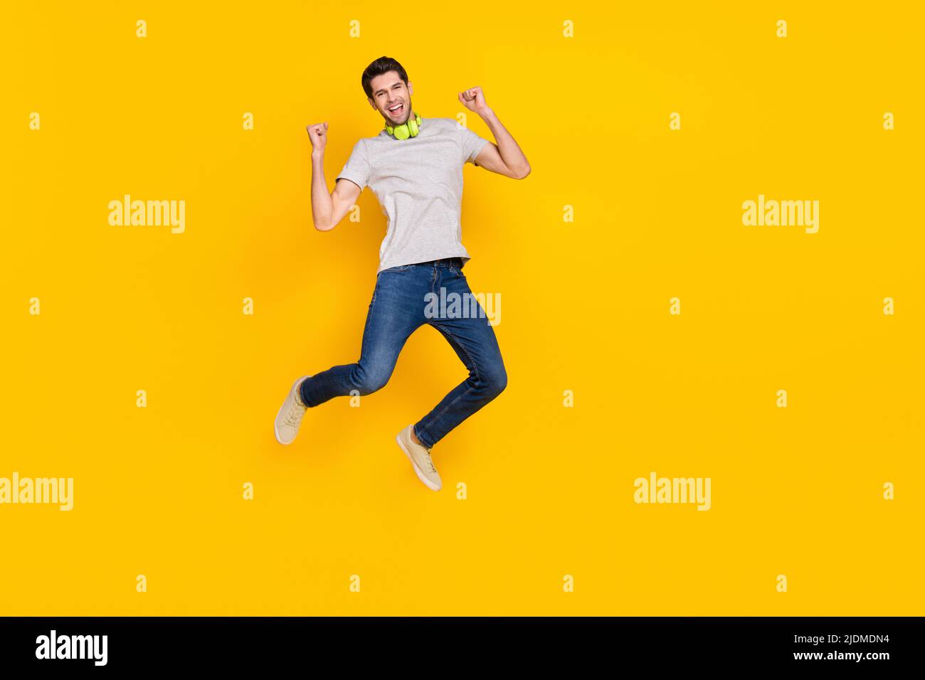Full length body size view of attractive cheerful lucky guy jumping ...