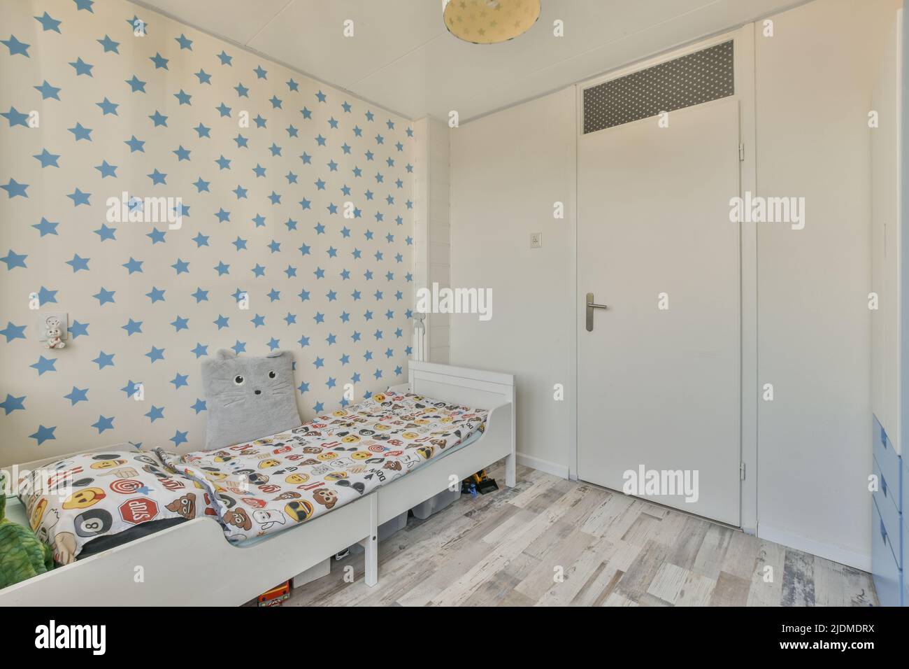 Interior of white room with children bed and blue wardope near window ...