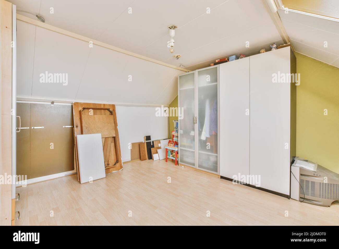 Modern cupboard and vintage chest placed near doors and wicker basket ...