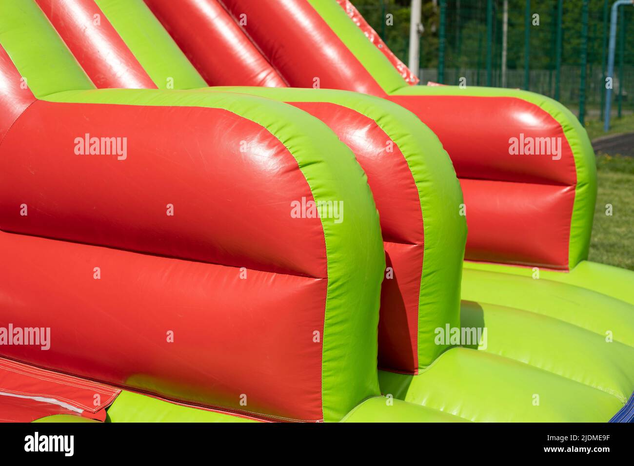 Red inflatable design. Inflatable slide. Obstacle course in amusement ...