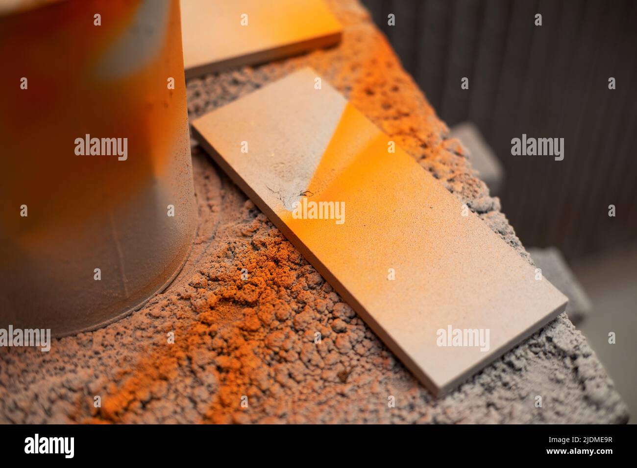 Orange paint in jar and board. Workplace with paint. Production in ...