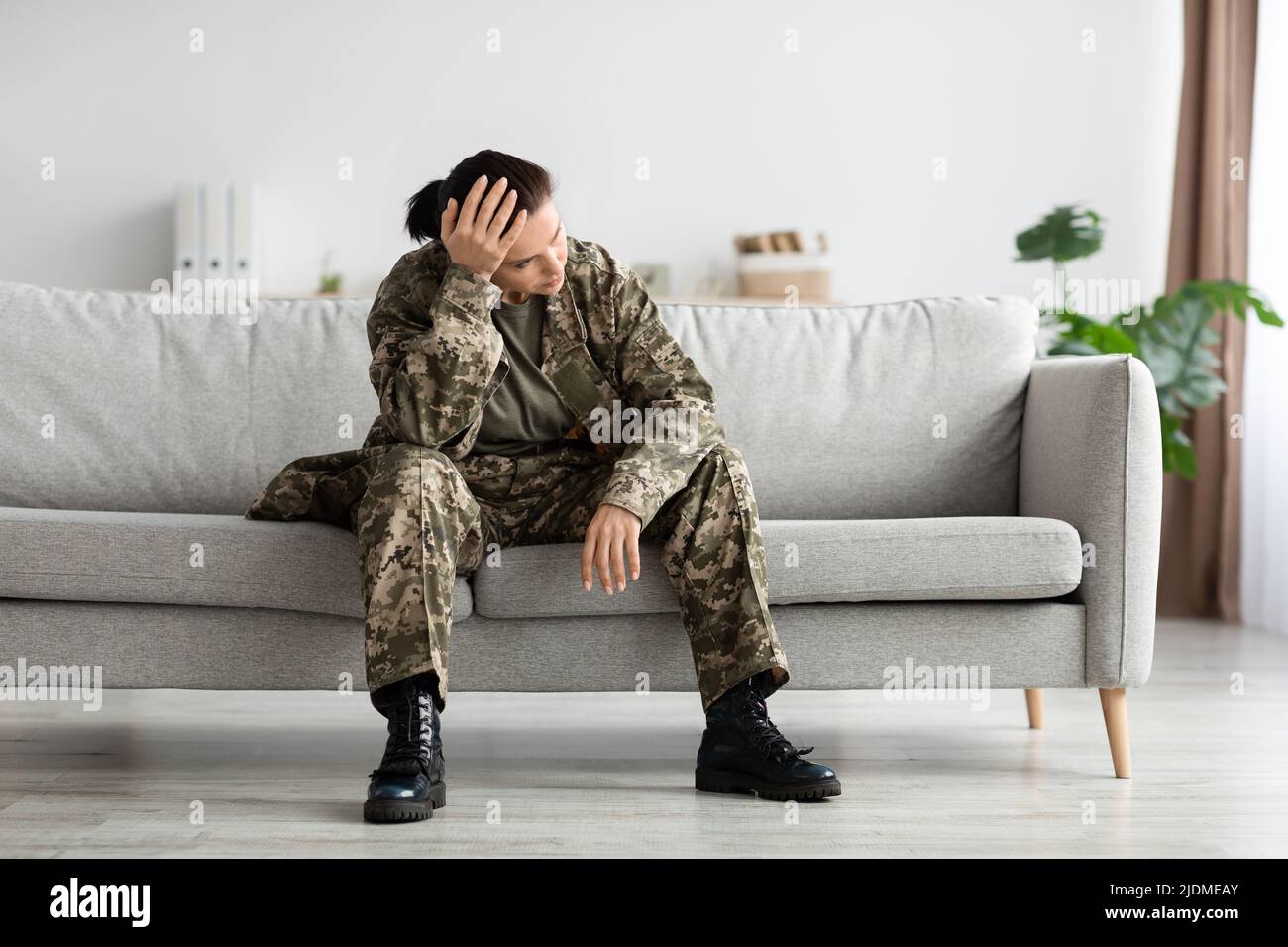 Mental Disorders In Military. Depressed Soldier Lady In Uniform Sitting ...