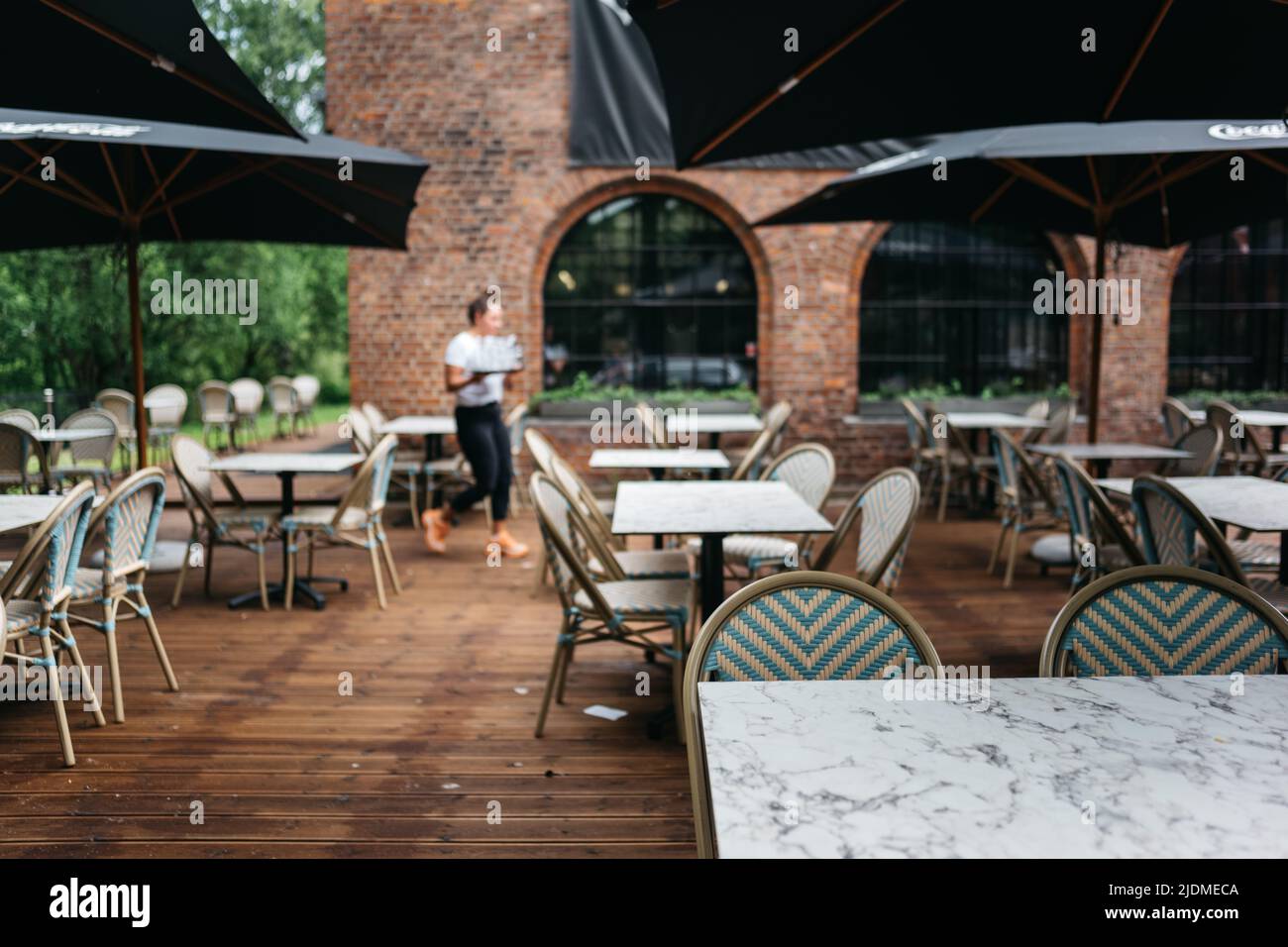 Outdoor restaurant with dish and flowers on the tables Stock Photo - Alamy
