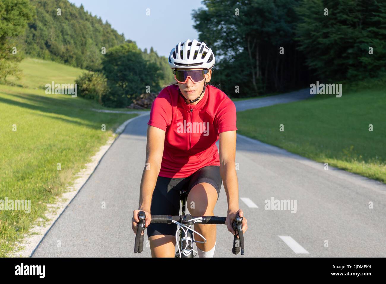Caucasian girl cyclist with professional racing sports gear riding on ...