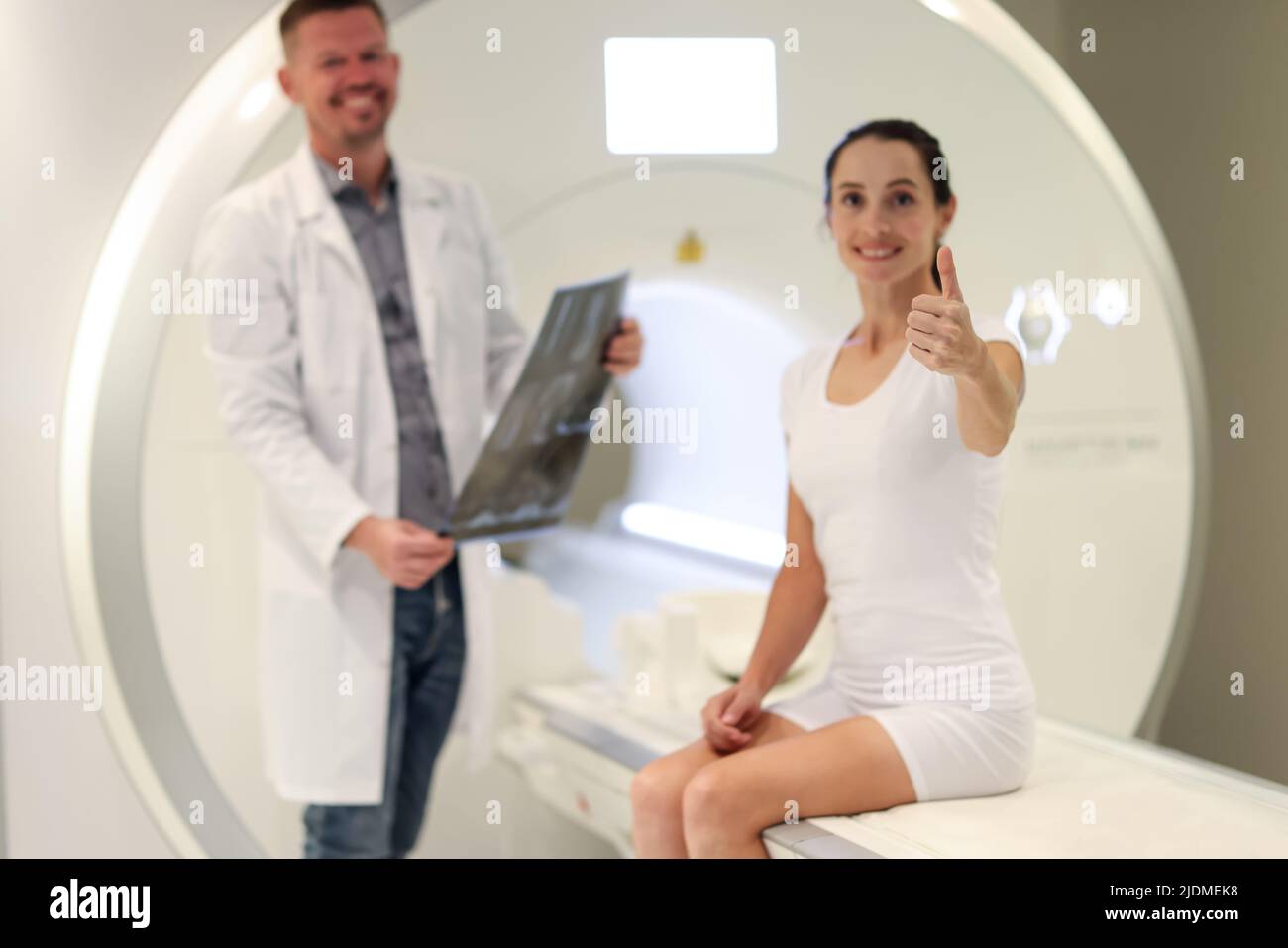 Smiling female patient showing thumbs up gesture at mri procedure Stock ...
