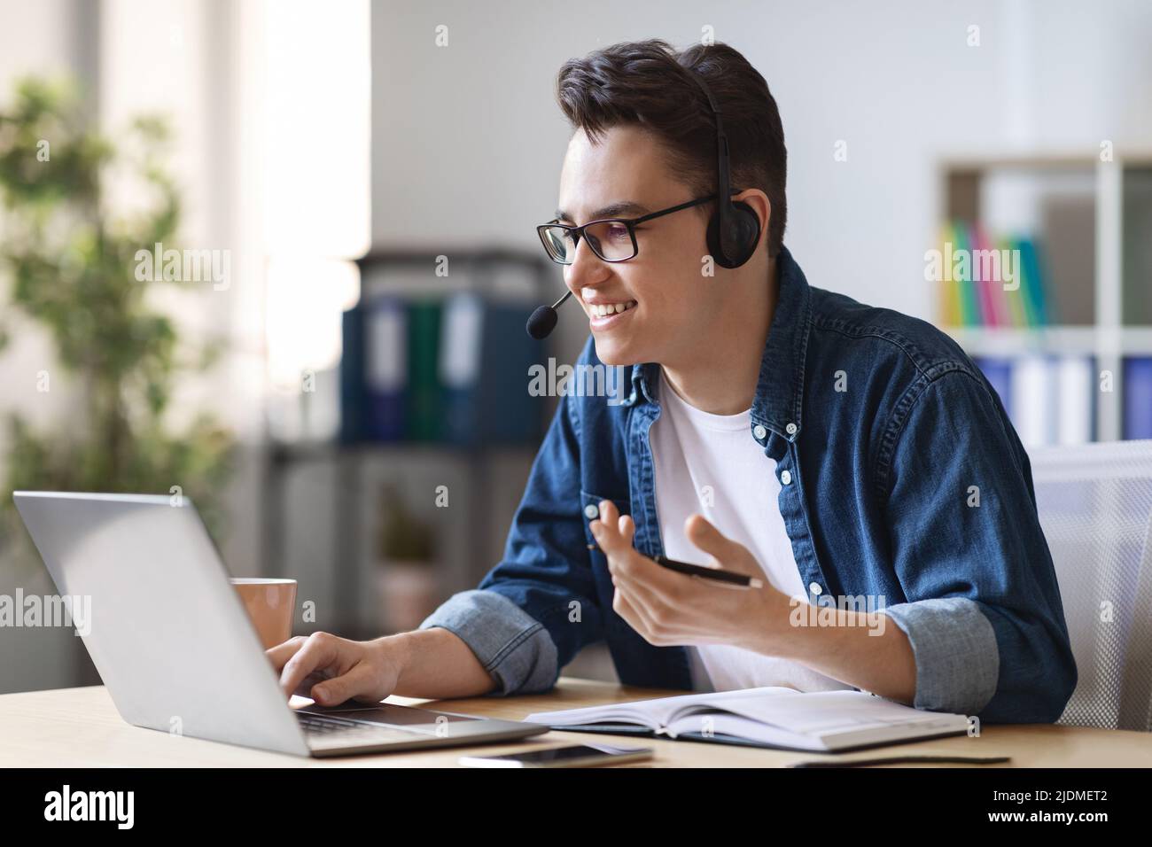 Web Conference. Smiling Millennial Male In Headset Making Video Call ...