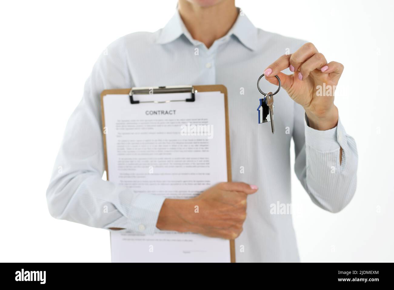 Real estate agent holding keys from new house and contract in hands ...