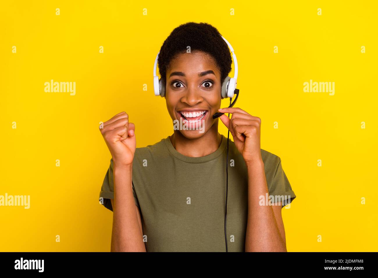 Photo of delighted excited person raise fists talk communicate mic ...