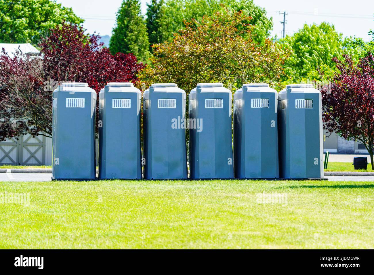 A row of portable toilets in a community park Stock Photo - Alamy