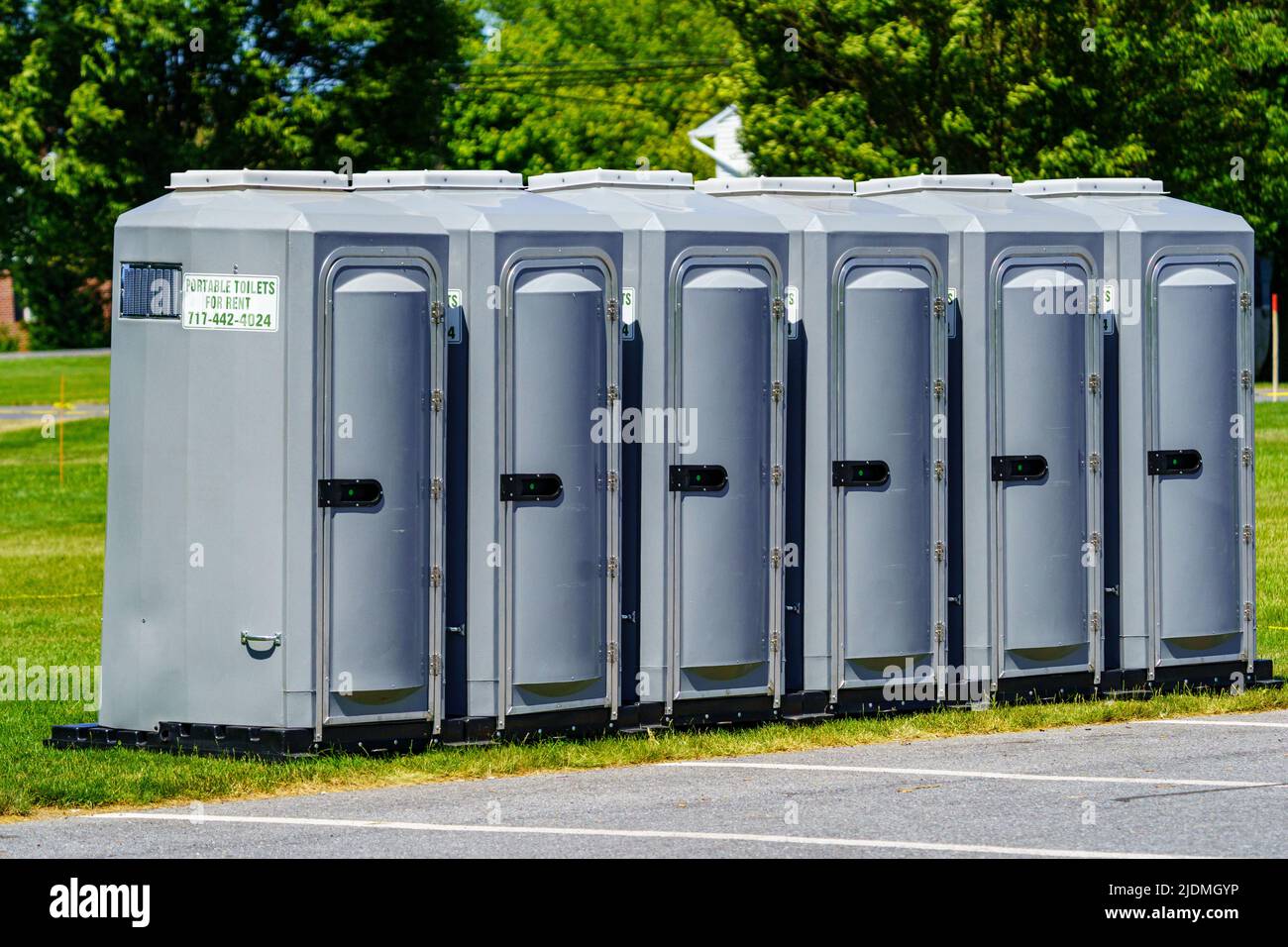 A row of portable toilets in a community park Stock Photo - Alamy
