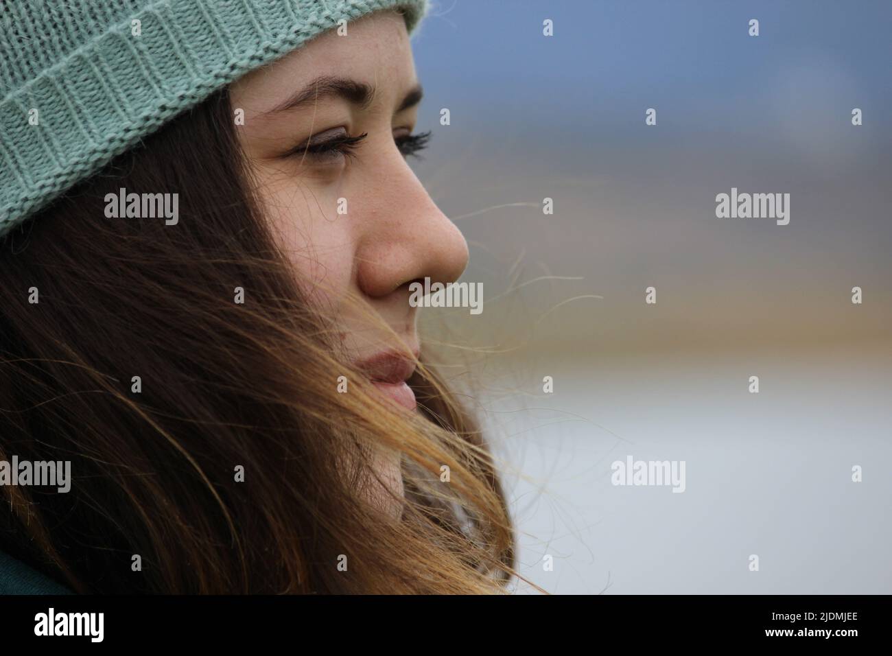 Portrait of a girl of European appearance with long hair on the street ...