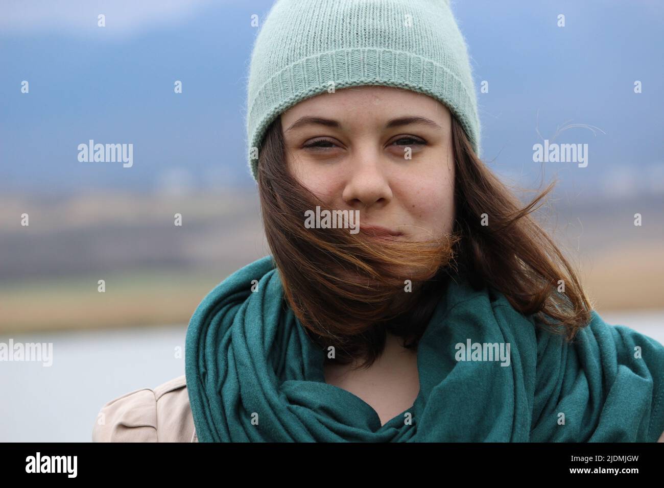 Portrait of a girl of European appearance with long hair on the street ...