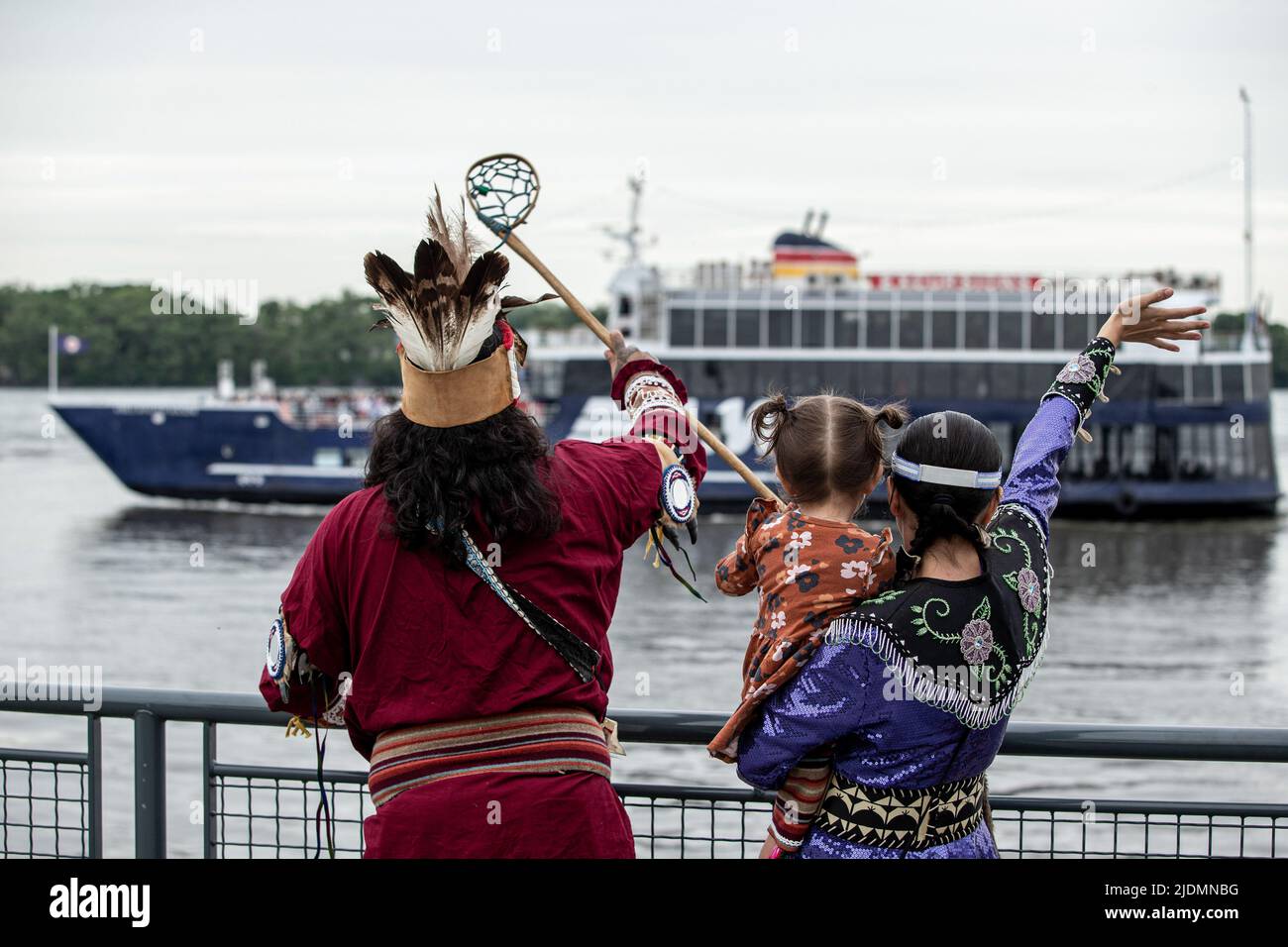 Two Indigenous dancers waving at a passing ship on the St. Lawrence ...