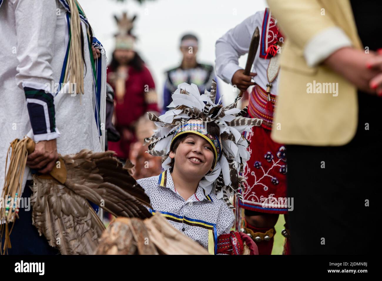 An Indigenous enfant surrounded by their family during the celebration ...