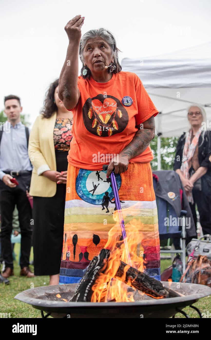 An Indigenous elder starts the ceremonial fire to celebrate the summer ...