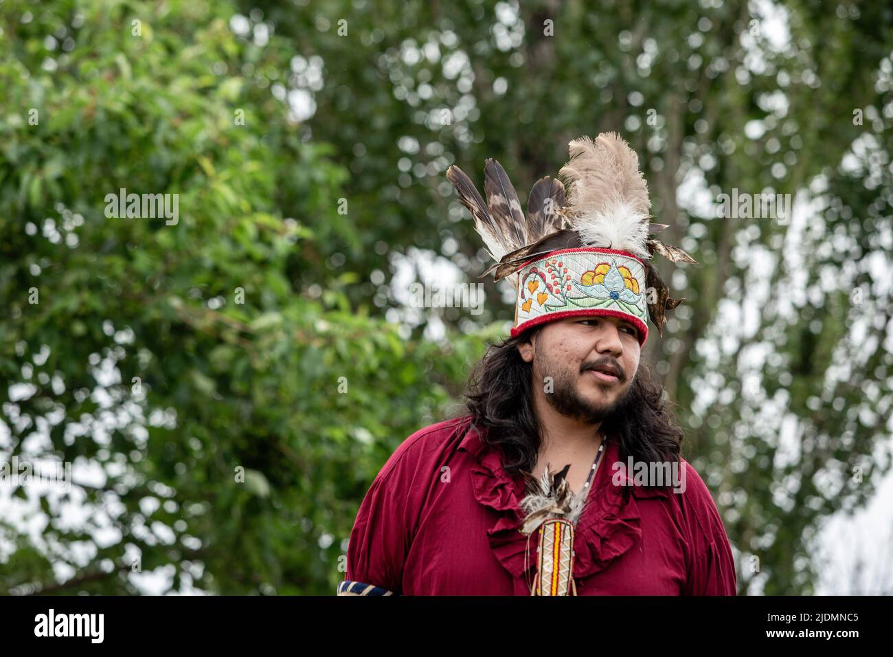 An Indigenous dancer watching the summer solstice ceremony. During this ...