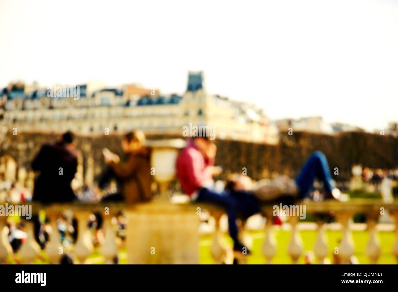Blurry photo of Luxembourg gardens in Paris, France. Couples relaxing ...