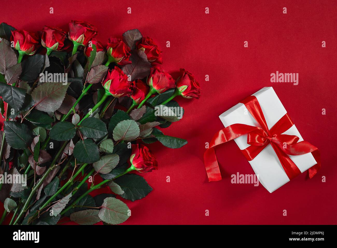 Top view fresh red rose flower and gift box on red deck with emp Stock ...