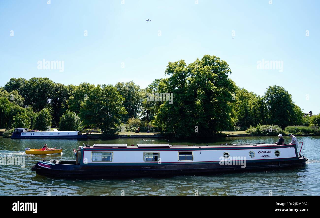 A narrowboat is driven along the River Thames in Windsor, Berkshire ...