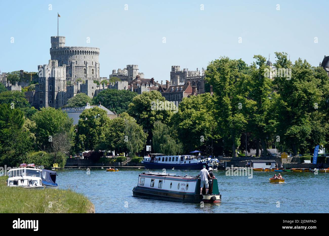 A narrowboat is driven along the River Thames in Windsor, Berkshire ...