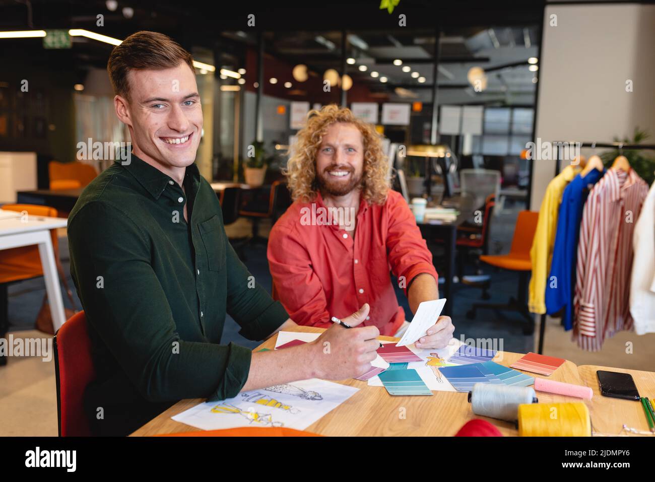 Portrait of smiling caucasian male fashion designers with various ...